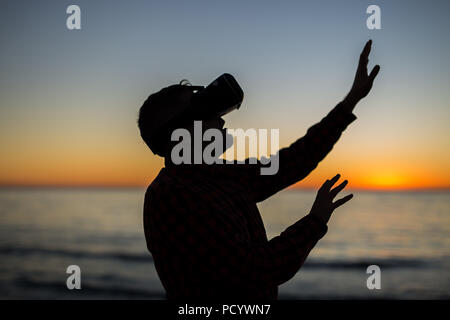 Virtual Realty is here Man wearing virtual reality glasses on the over ...