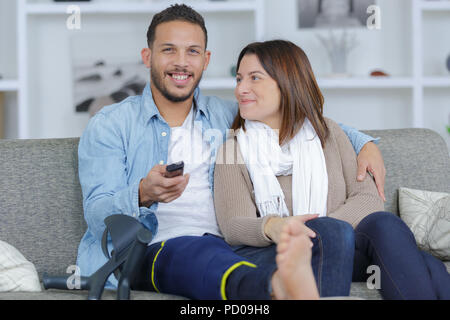 injured boyfriend and girlfriend watching tv at home Stock Photo - Alamy