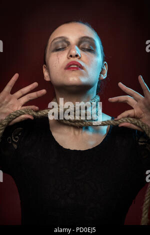 Woman with rope noose on neck against white background, back view Stock ...