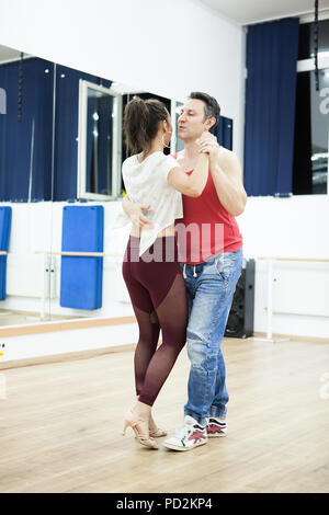 Passion, emotions. Man and woman, professional tango dancers in stylish ...