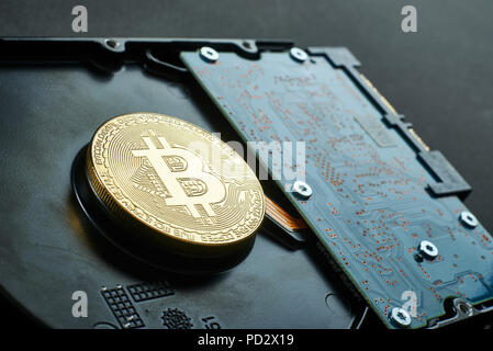 Golden Bitcoin on digital pc hard disk.Virtual money Stock Photo - Alamy