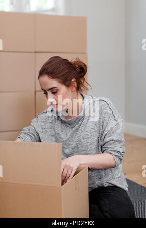 Open cardboard box on the floor in empty room, ready for transport ...