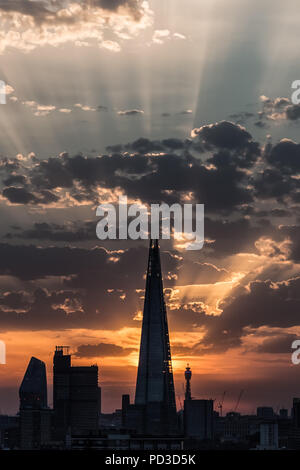 London 6th August 2018: Rays of sun at sunset over East London. Seen ...