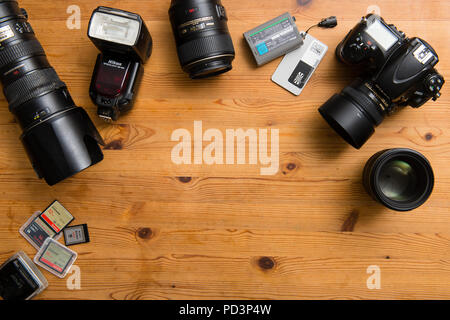 Top down view of camera equipment on white tabletop, DSLR with ...