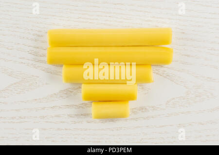 Group of five whole smoked slovak string cheese stick flatlay on grey ...