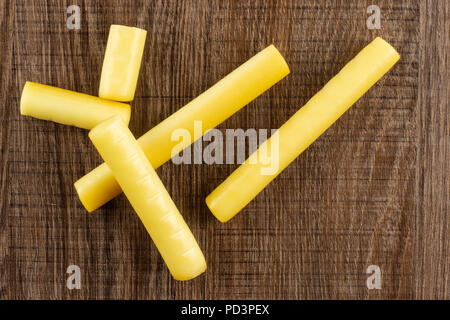 Group of five whole smoked slovak string cheese stick flatlay on grey ...