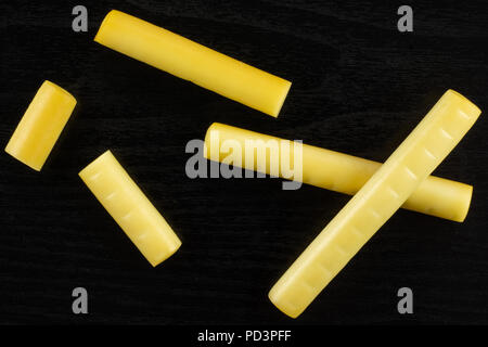 Group of five whole smoked slovak string cheese stick flatlay on grey ...