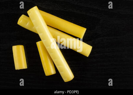 Group of five whole smoked slovak string cheese stick flatlay on grey ...