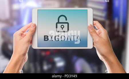 Data written on tablet screen with hands holding the device up with ...