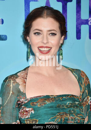 In this July 31, 2018 photo, Kami Stahl, foreground, passes a dish of ...