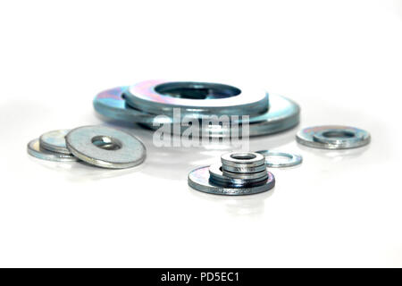 Variety of industrial galvanized steel washers on white background ...