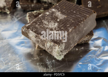 Moldy chocolate in the original packaging. Out-dated food products used ...