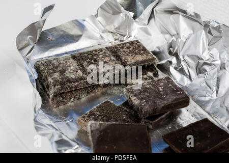 Moldy chocolate in the original packaging. Out-dated food products used ...