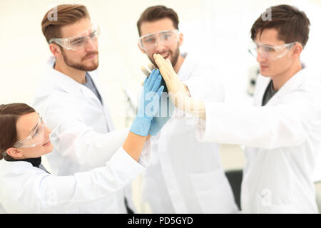 scientists giving each other a high five Stock Photo - Alamy