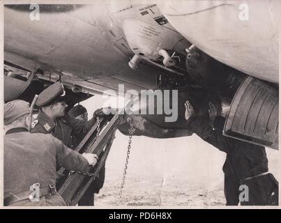 World War Two Crew loading ammunition into the wing of a P 47 ...