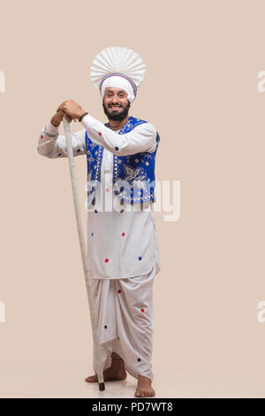 A Bhangra Dancer standing with a Khunda Stock Photo - Alamy