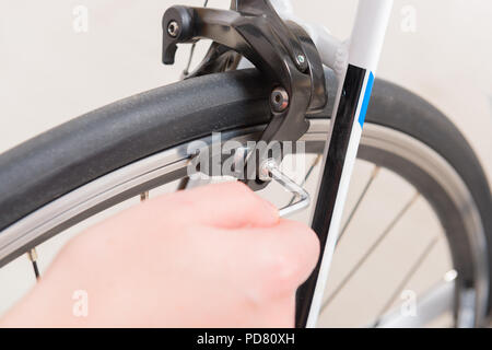 Hand adjusting bicycle's brakes Stock Photo - Alamy