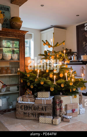 Wrapped Christmas gift boxes in kraft paper on wooden table with wide ...