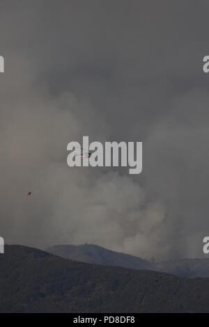 Helicopters drop water on a fire burning in Creightons Creek. (Photo by ...