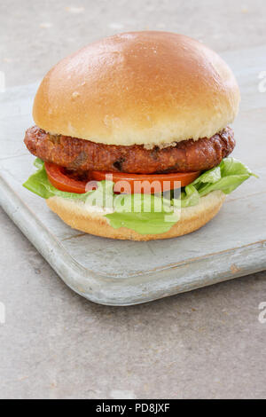 Beefburger in brioche burger bun with home made chips Stock Photo - Alamy