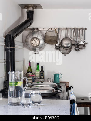 Kitchen utensils colander hanging above sink by window plants bluebells ...