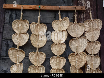Native fan made from palm leaves at street market in Manila ...