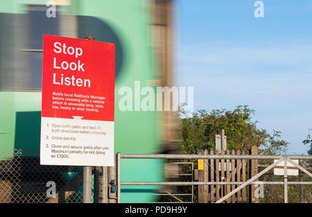 Stop sign at railway crossing Stock Photo - Alamy