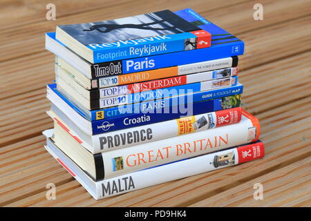 Stack of European travel guide books on white Stock Photo - Alamy