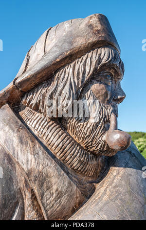 wooden statue of man smoking a pipe Stock Photo - Alamy