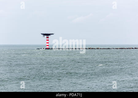 The red and white striped lighthouse with heliplatform at the entrance ...
