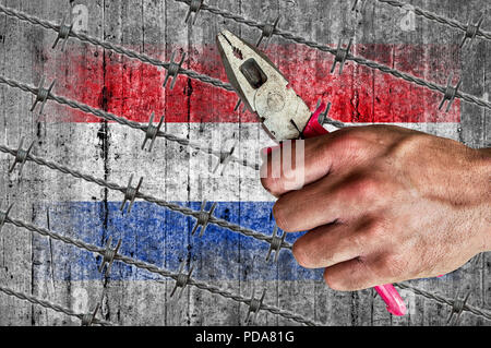 Netherland flag, STOP sign, migrants and barb wire with pliers Stock ...