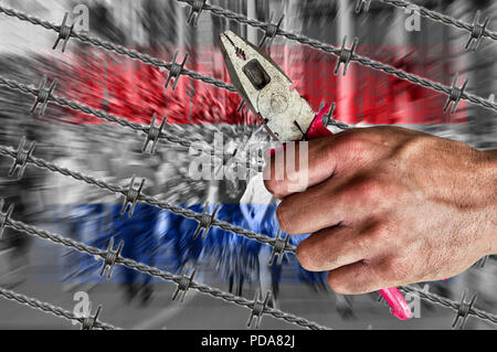 Netherland flag, STOP sign, migrants and barb wire with pliers Stock ...