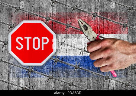 Netherland flag, STOP sign, migrants and barb wire with pliers Stock ...