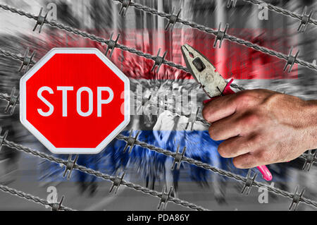 Netherland flag, STOP sign, migrants and barb wire with pliers Stock ...