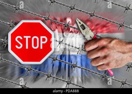 Netherland flag, STOP sign, migrants and barb wire with pliers Stock ...