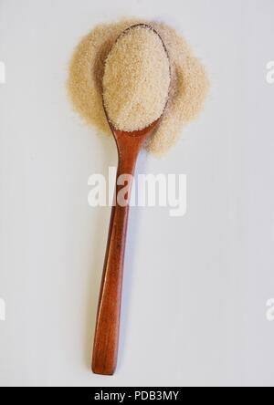 Brown powdered sugar in a spoon Stock Photo - Alamy