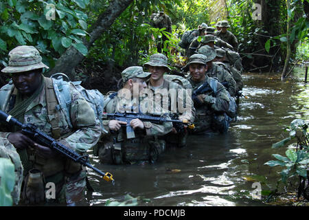 U.S. Army Soldiers wade through the water of the jungle during Jungle ...