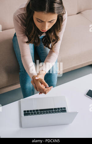 Woman having wrist pain when using mouse during working long time on ...