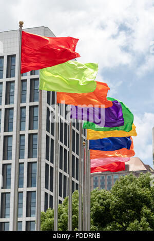 Various single-colour flags flying from a row of flag poles in Shanghai ...