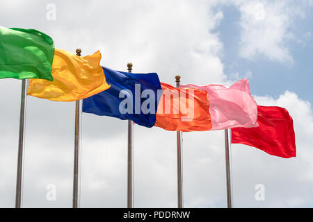 Various single-colour flags flying from a row of flag poles in Shanghai ...