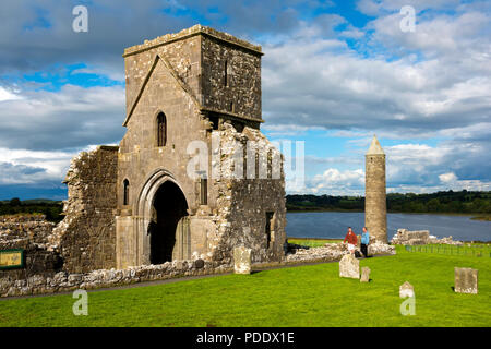 Devenish Island round tower and monastic ruins seen from east shore of ...
