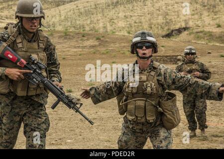 U.S. Marine Corps Sgt. Kathrine E. Cleary, left, combat instructor, School of Infantry (SOI ...