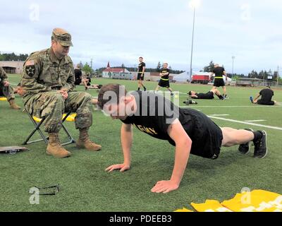 U.S. Army soldiers perform push ups during physical training at the ...