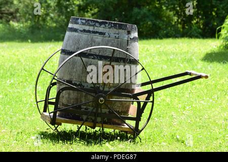 Barrel in a cart with big wheels Stock Photo - Alamy
