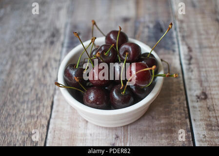 Appetizing Fresh Morello Cherries in white bowl on wooden table top ...