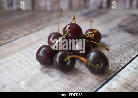 Appetising fresh Morello Cherries on wooden table top Stock Photo - Alamy