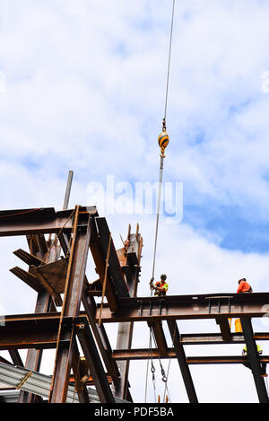 Construction worker on steel beam at construction site Stock Photo ...