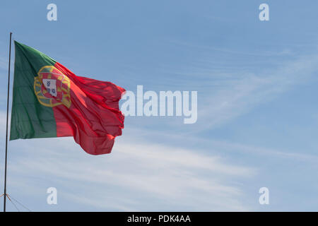 Portuguese flag waving in front of blue sky Stock Photo - Alamy