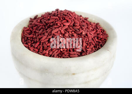 Red yeast fermented rice on white background Stock Photo - Alamy