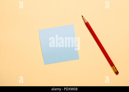 A white note and a blue pencil with red hearts on pink background Stock ...